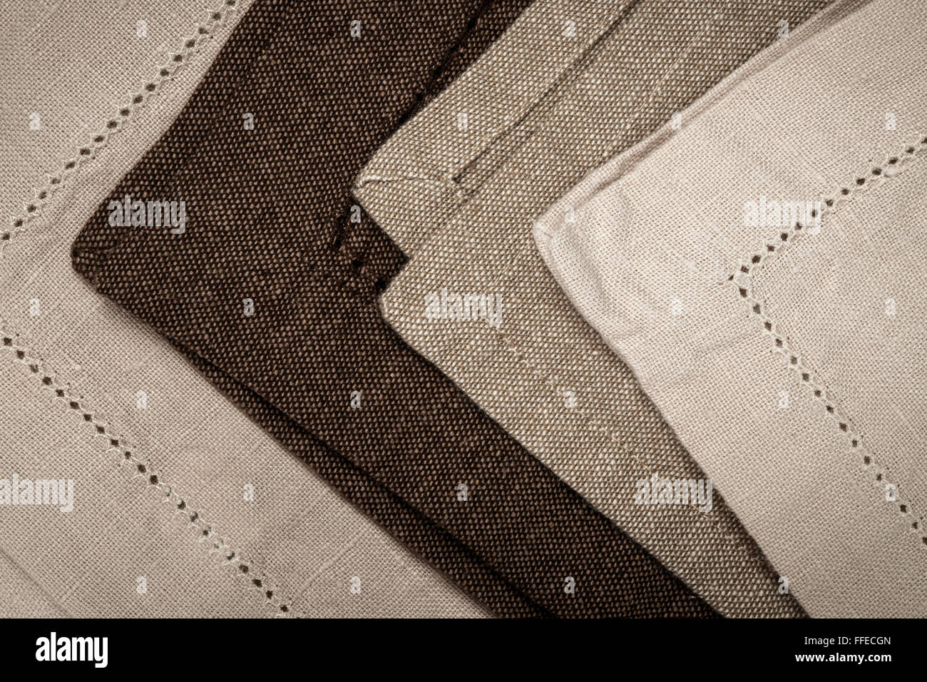 Edges of linen cloth napkins in brown and beige natural colors close up ...