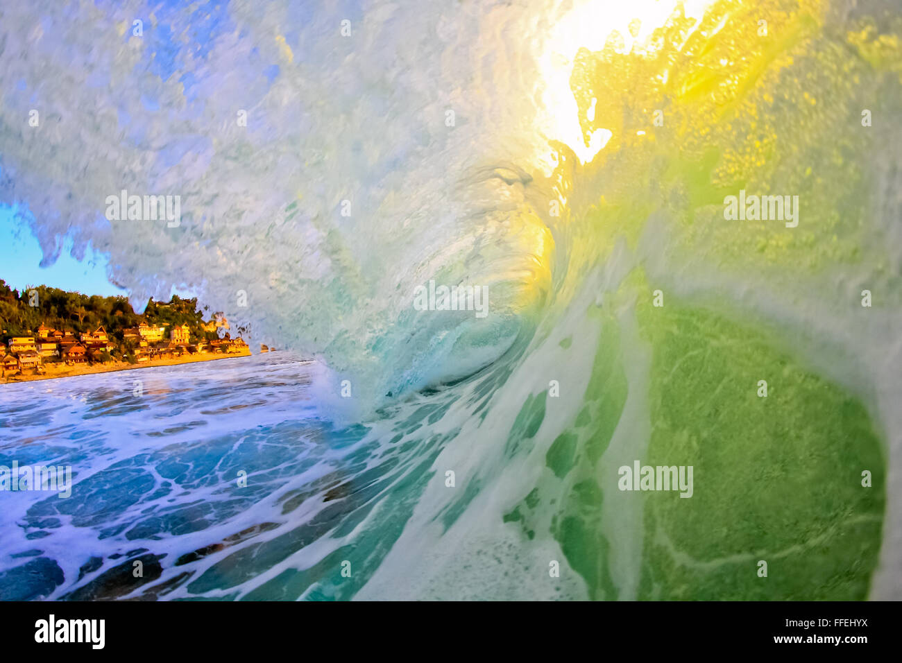View from the inside of a wave at sunset Stock Photo - Alamy