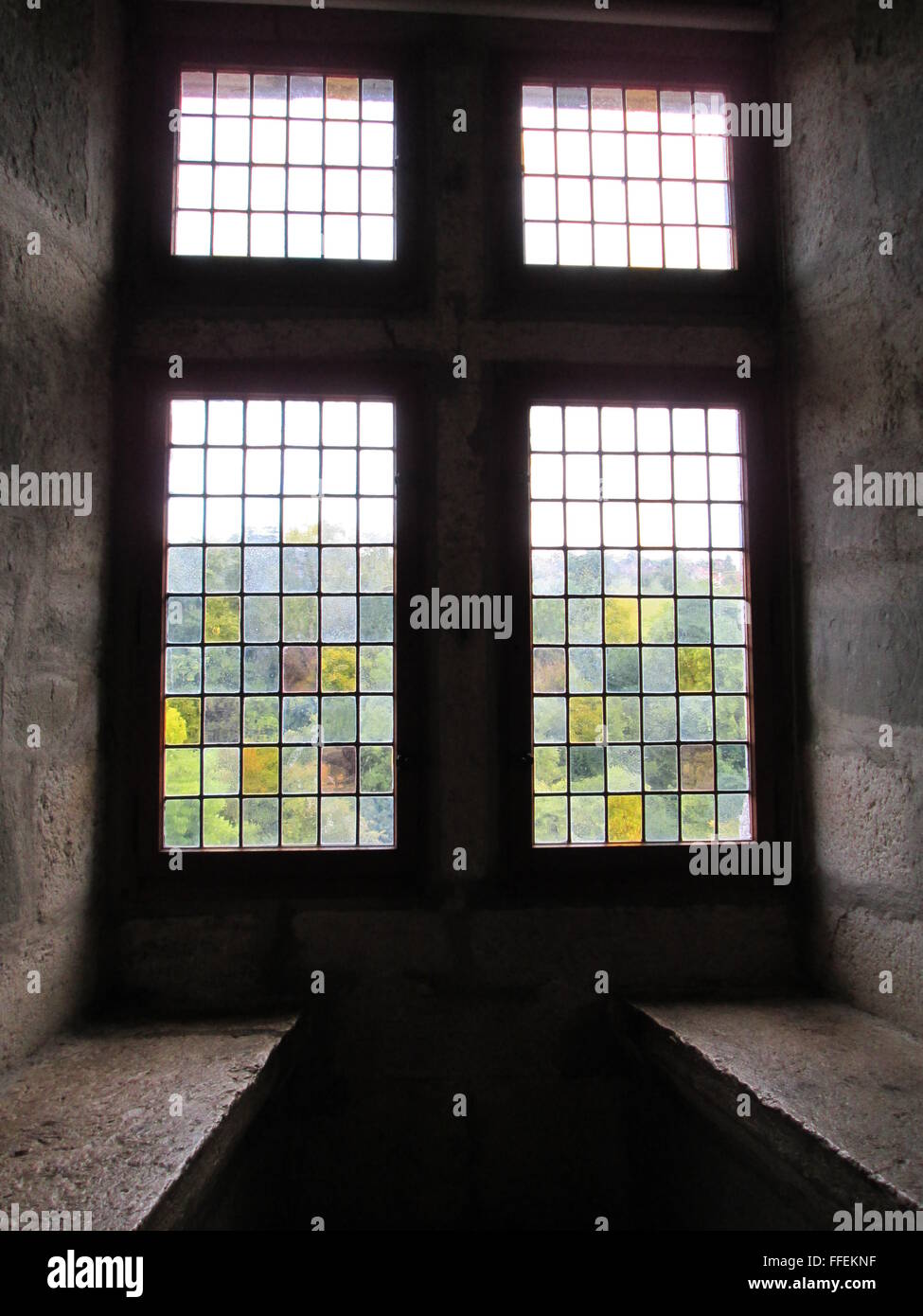Ancient window with small glass and colored background Stock Photo - Alamy