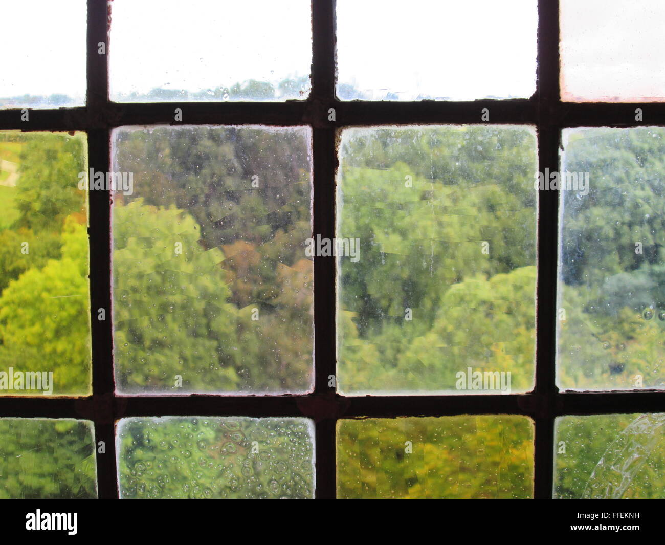Ancient window with small glass and colored background Stock Photo - Alamy