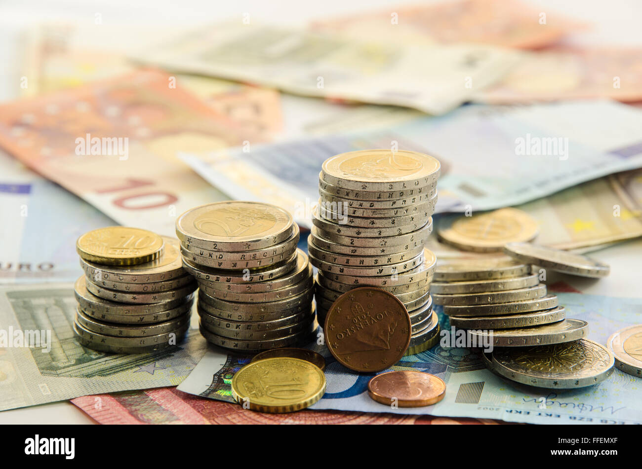 banknotes and pile of coins Stock Photo - Alamy
