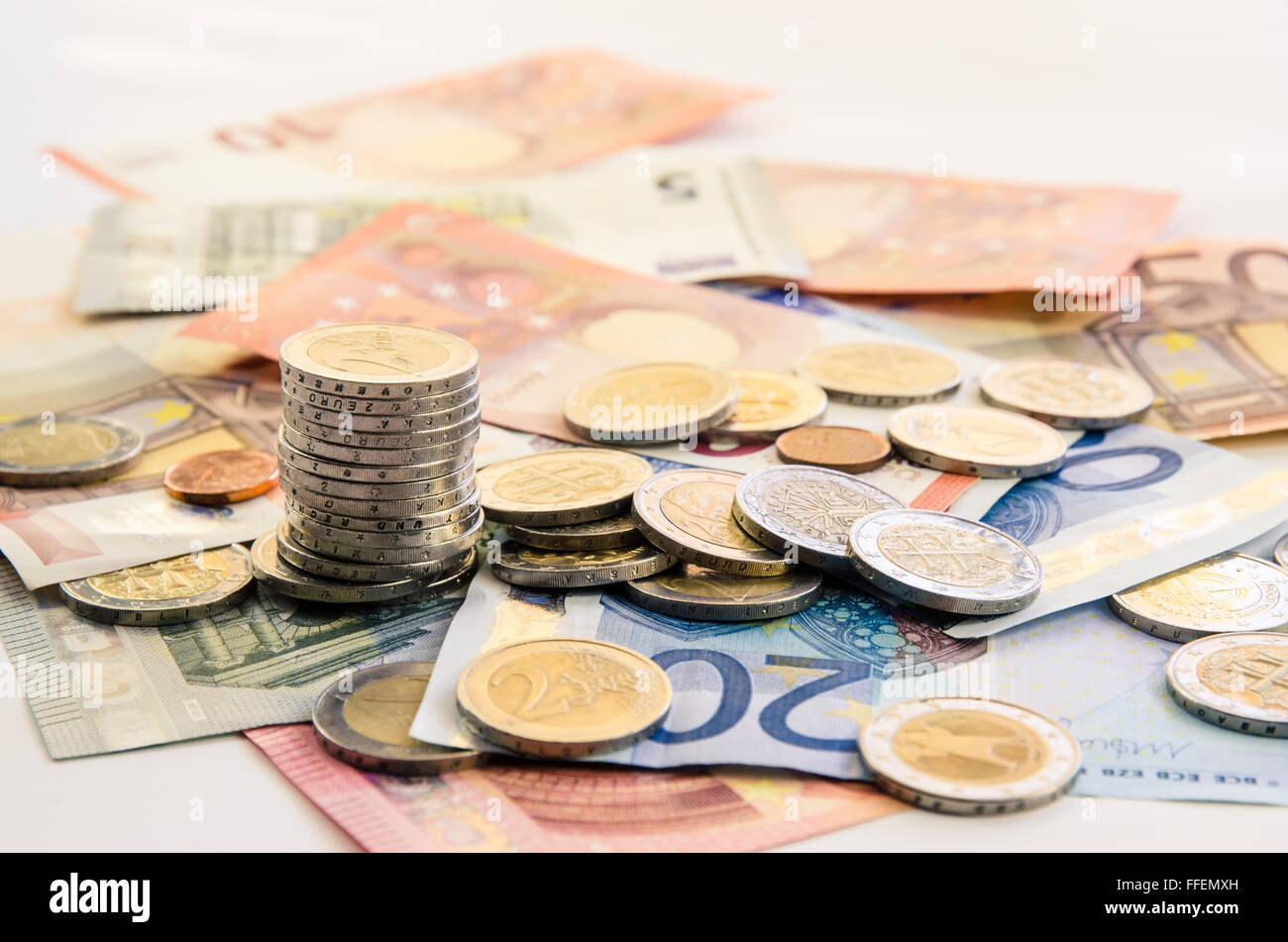 banknotes and pile of coins Stock Photo - Alamy