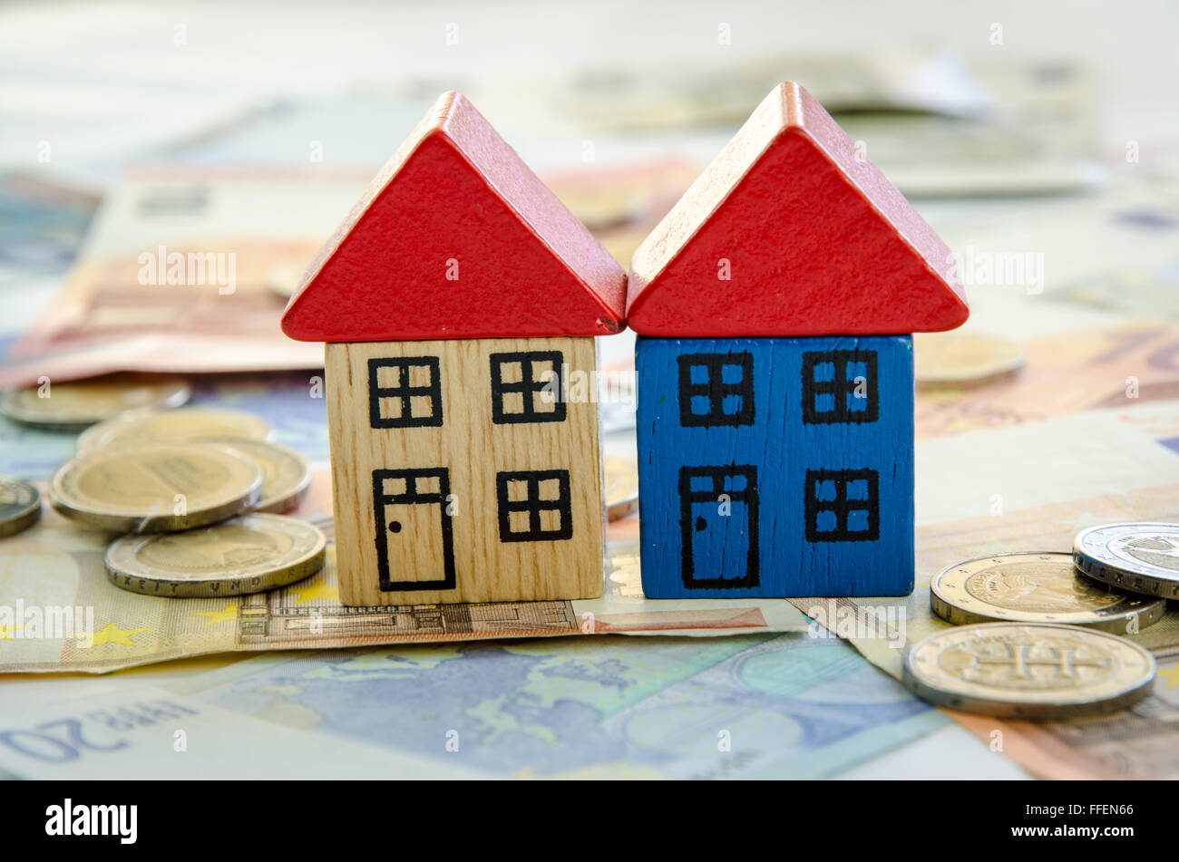 wooden toy house, banknotes and coins Stock Photo - Alamy