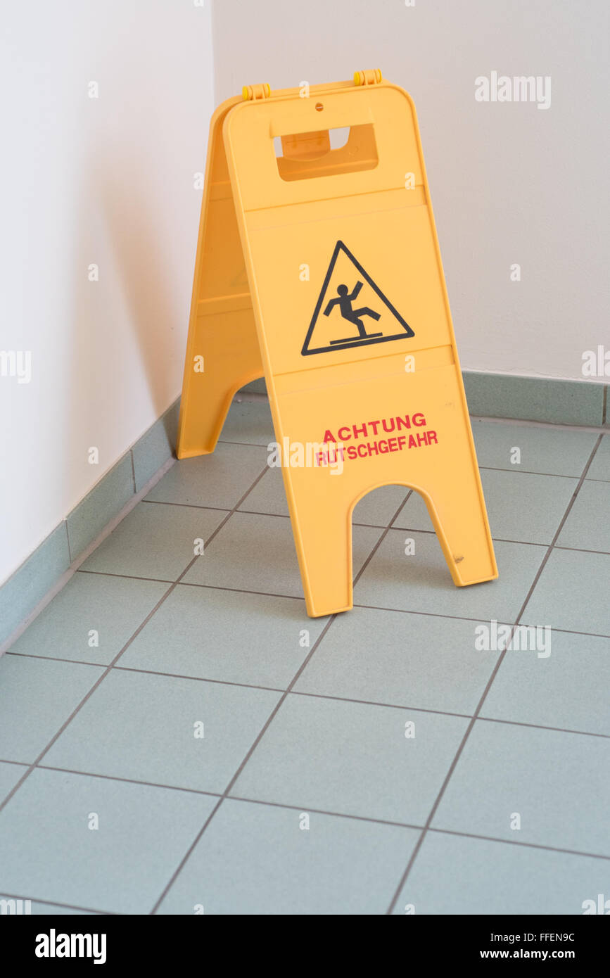 sign for slippery tile floor, indoors, danger Stock Photo - Alamy