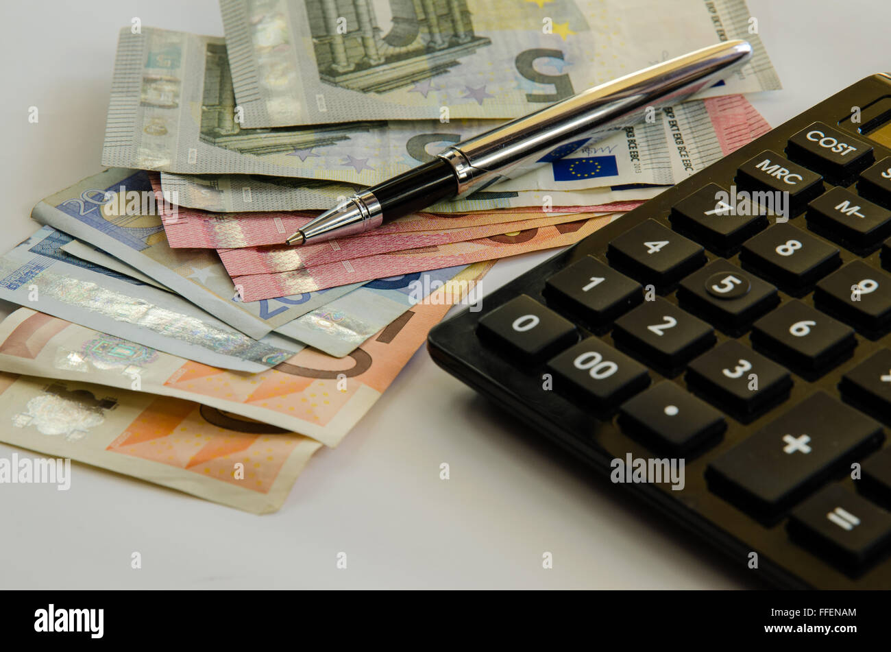 banknotes,coins, calculator and pen Stock Photo - Alamy