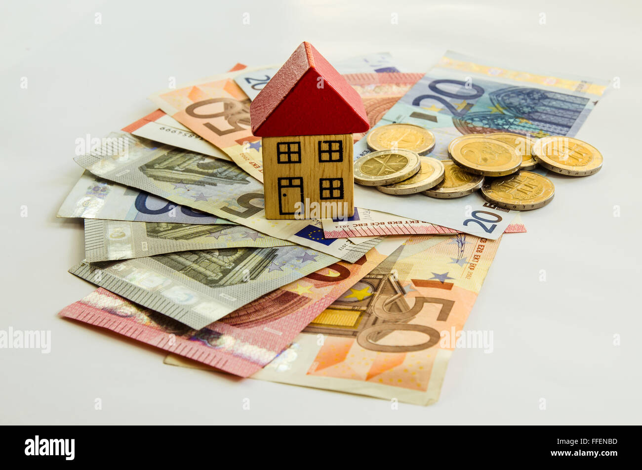 wooden toy house, banknotes and coins Stock Photo - Alamy