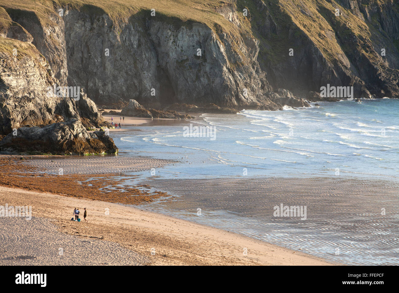 People on the the beach at Holywell Bay, North Cornwall in evening ...