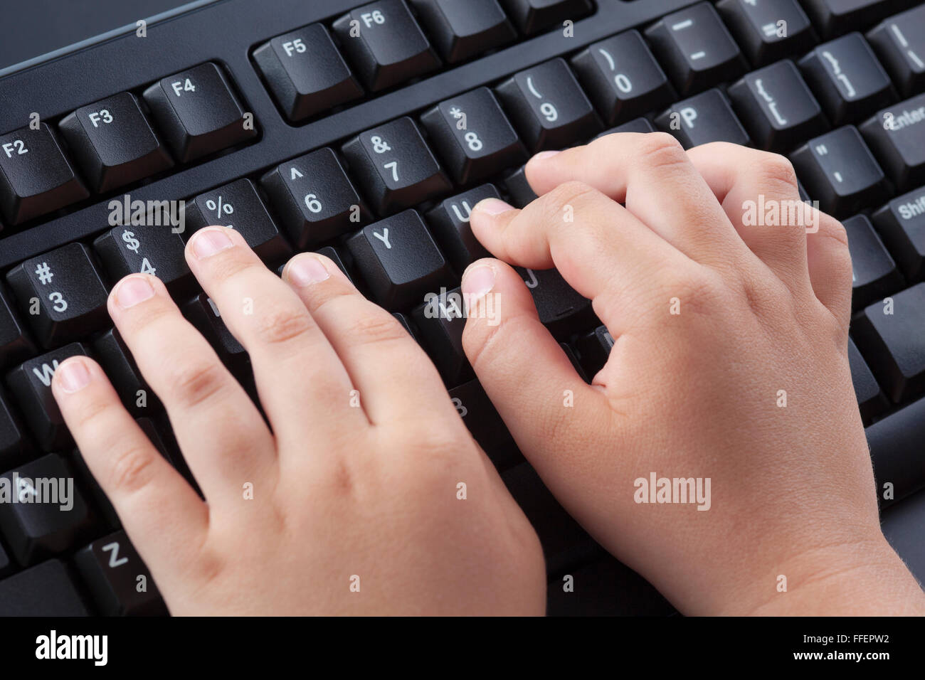 Child typing something on black computer keyboard. Closeup Stock Photo ...