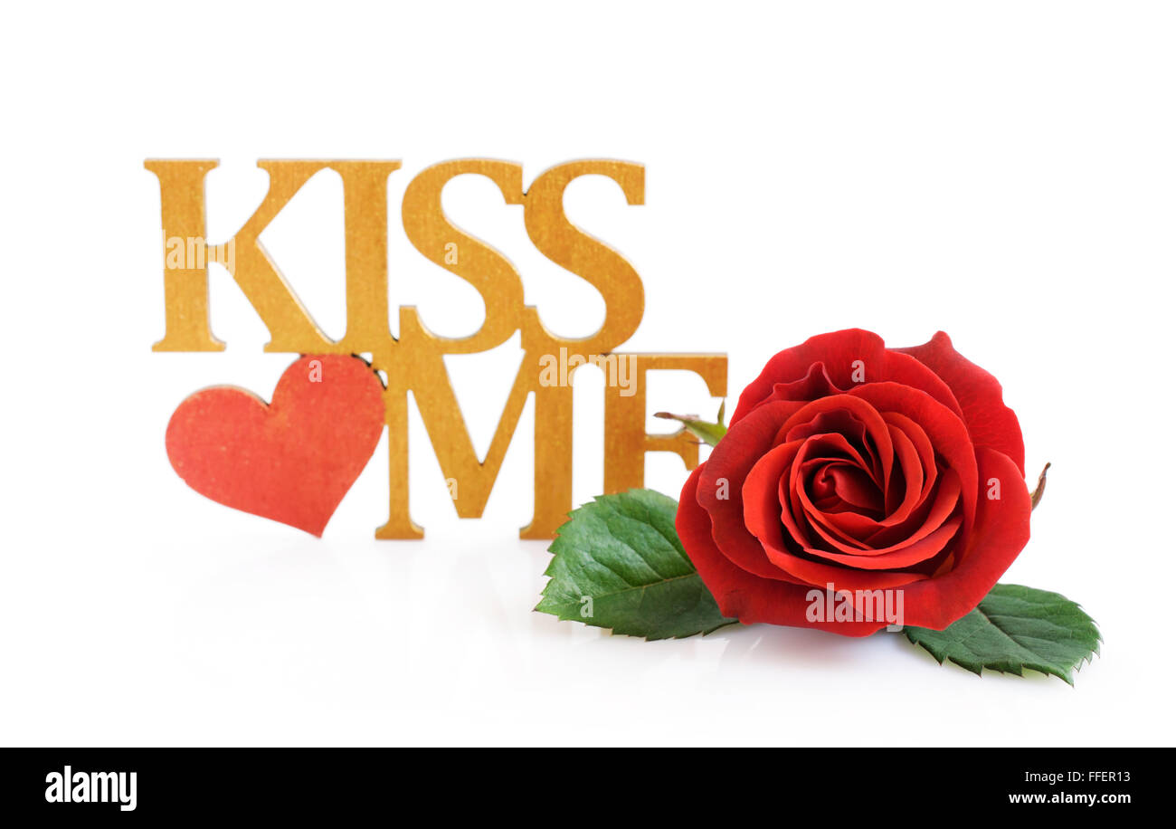 Red rose and golden words "Kiss me" isolated on a white background ...
