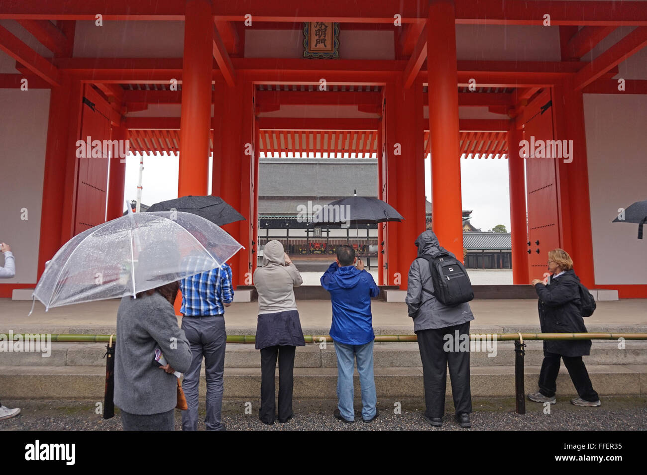 People taking photos of the Imperial Palace, Kyoto, Japan, in the rain ...