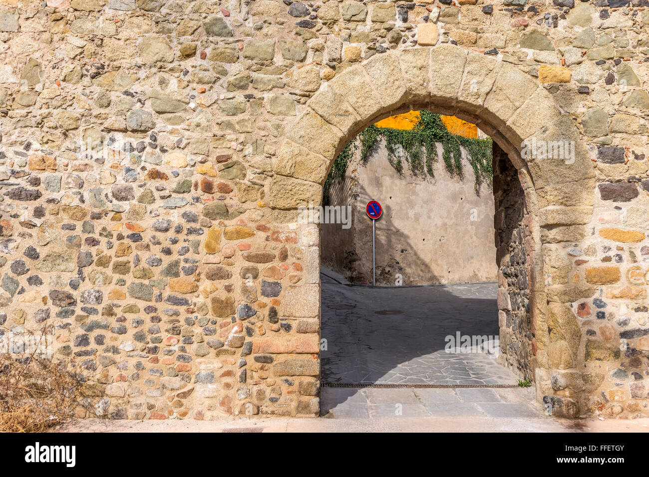 An old arched entrance to a Spanish village Stock Photo - Alamy