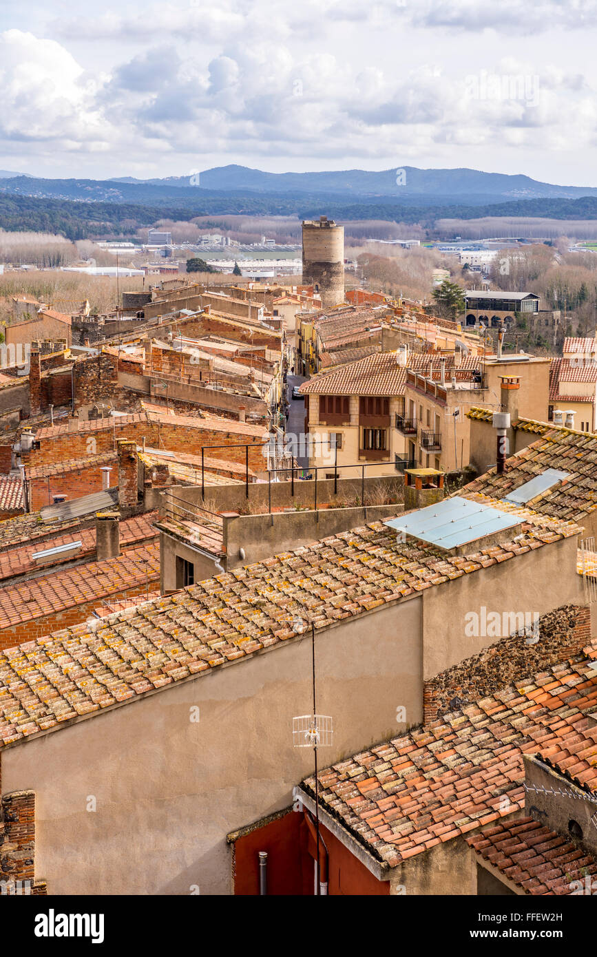 The view of the rooftops of a Spanish village with mountains in the ...