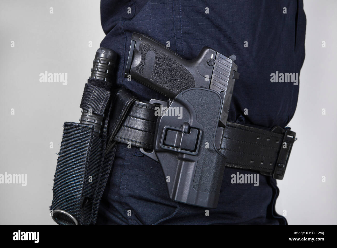 Policeman with gun Stock Photo - Alamy