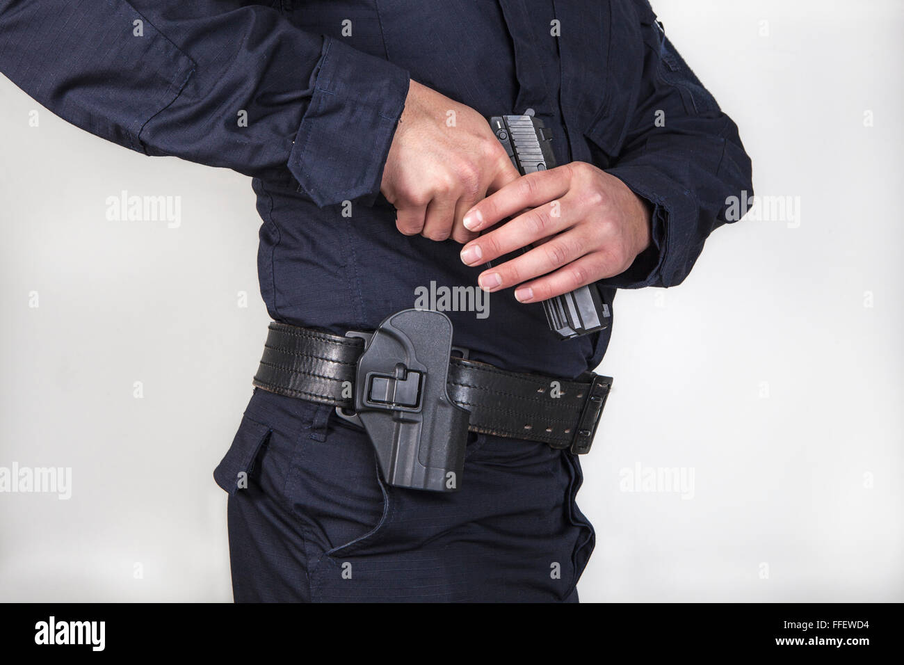 Policeman with gun Stock Photo - Alamy