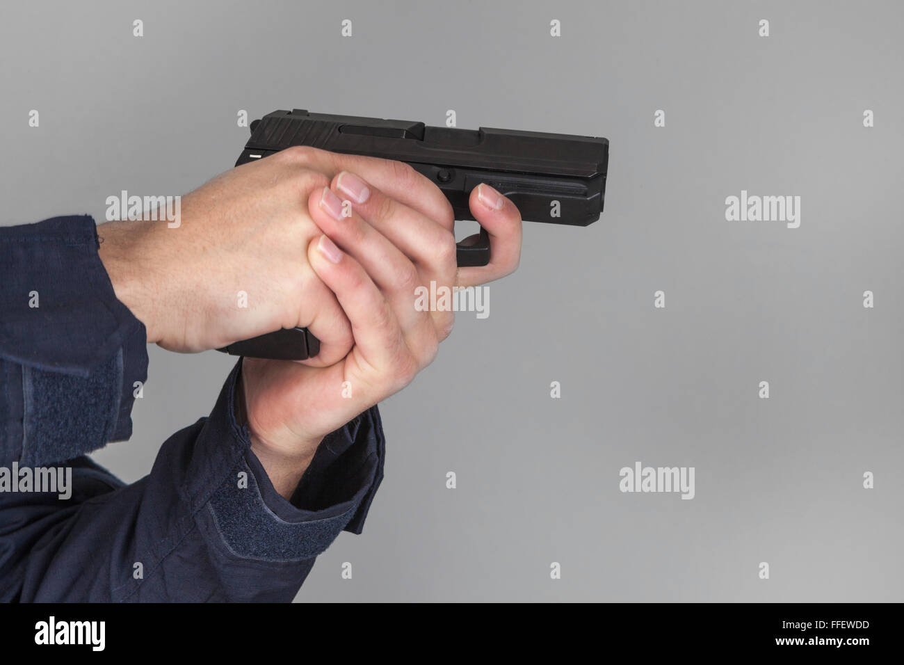 Policeman with gun Stock Photo - Alamy