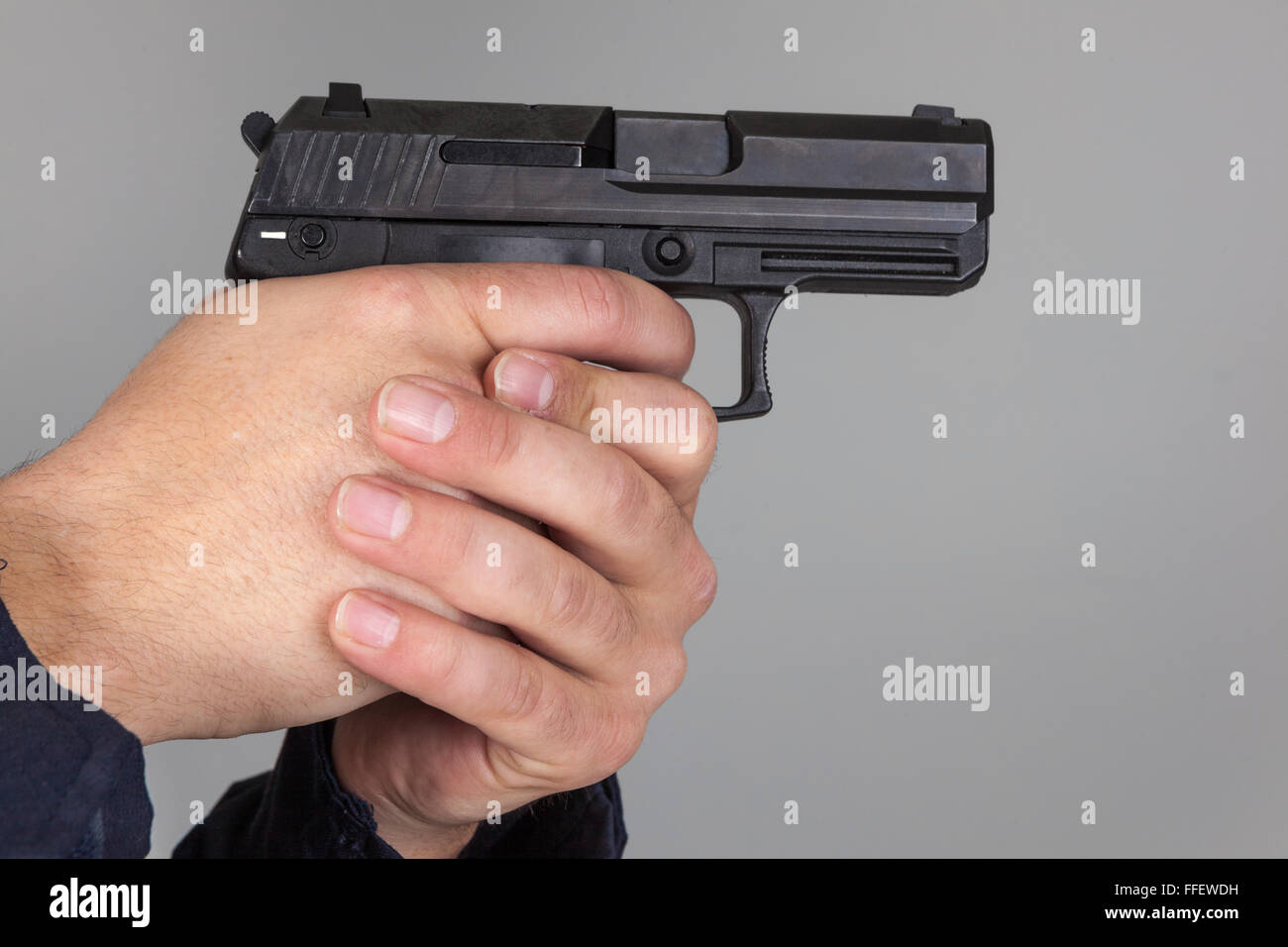 Policeman with gun Stock Photo - Alamy