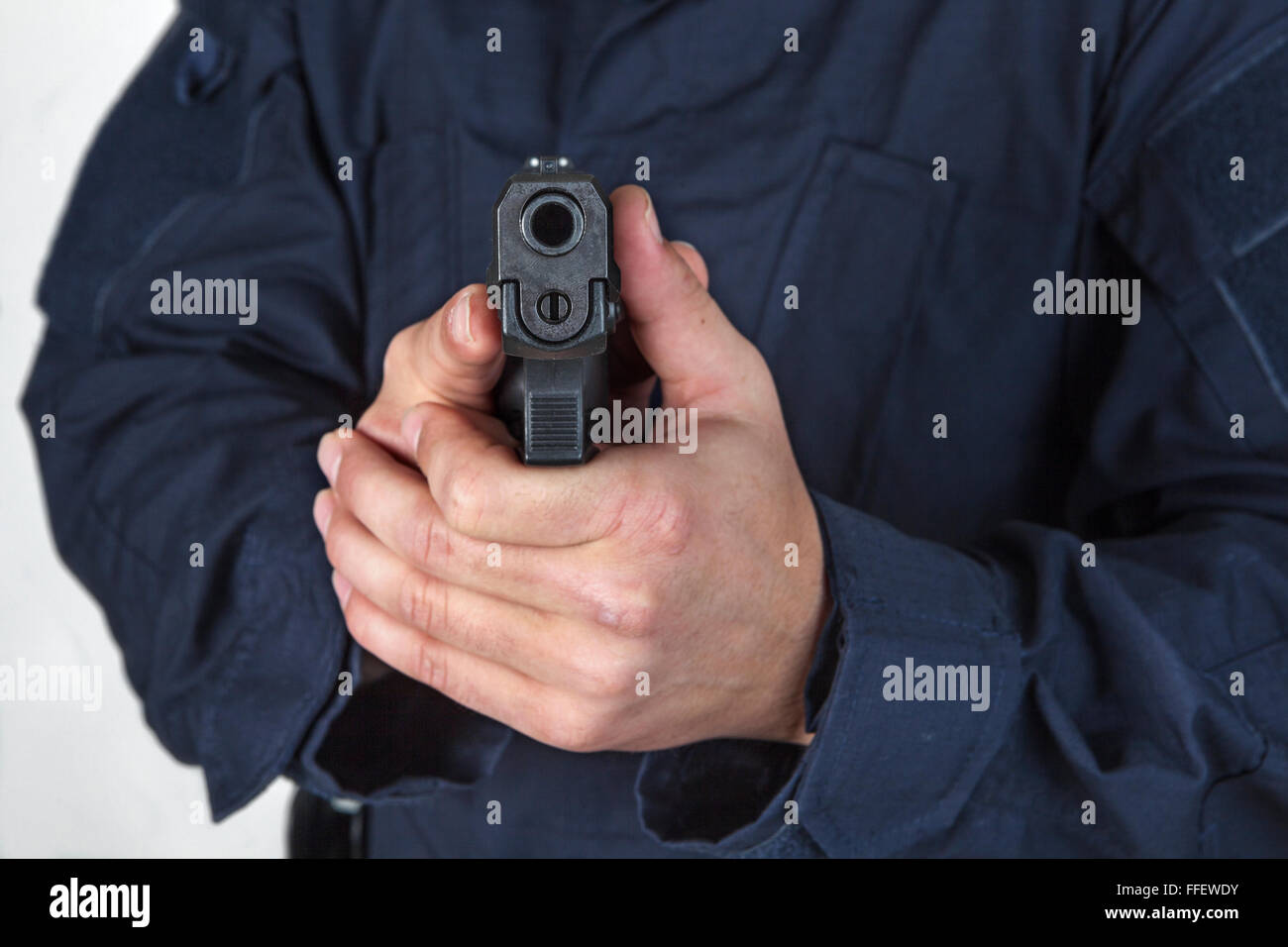 Policeman with gun Stock Photo - Alamy