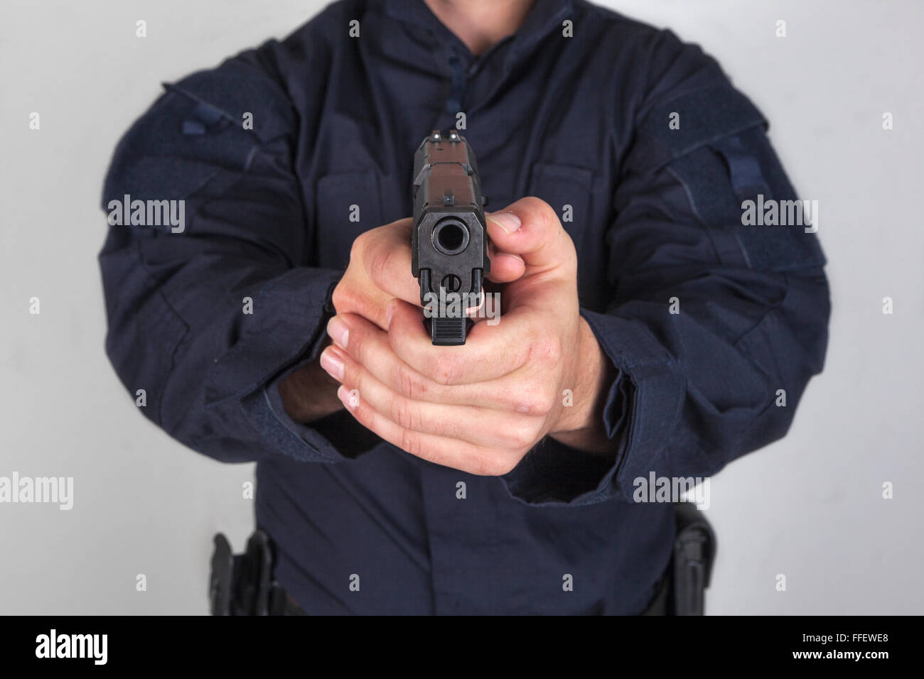 Policeman with gun Stock Photo - Alamy