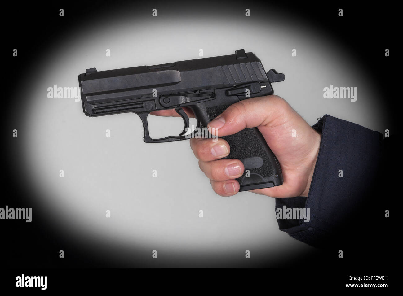 Policeman with gun Stock Photo - Alamy