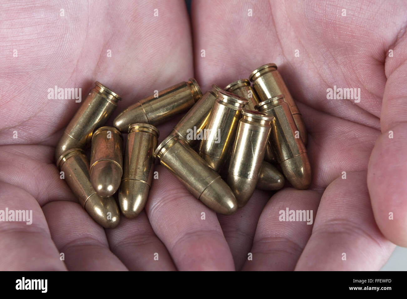 Man with bullets on his hands Stock Photo - Alamy