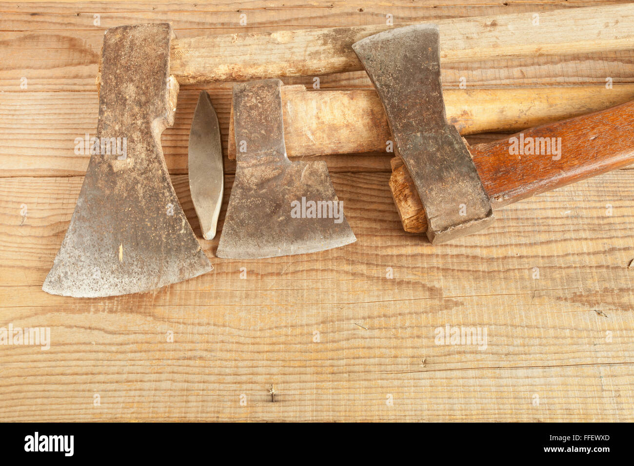 Three dated and used cleavers on wooden background Stock Photo - Alamy