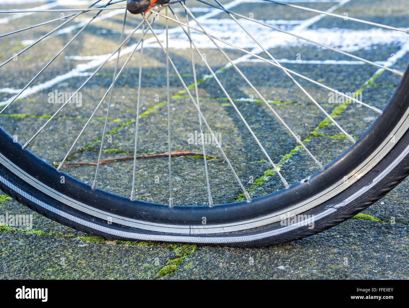 A bike wheel with a flat tire Stock Photo - Alamy