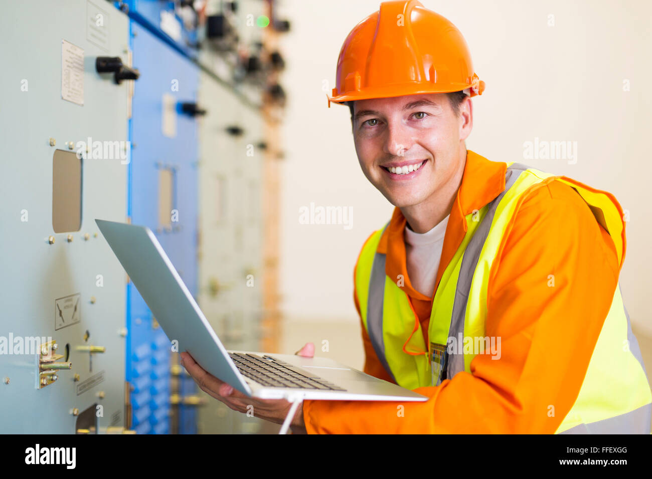 electrical worker with laptop computer in control room Stock Photo - Alamy