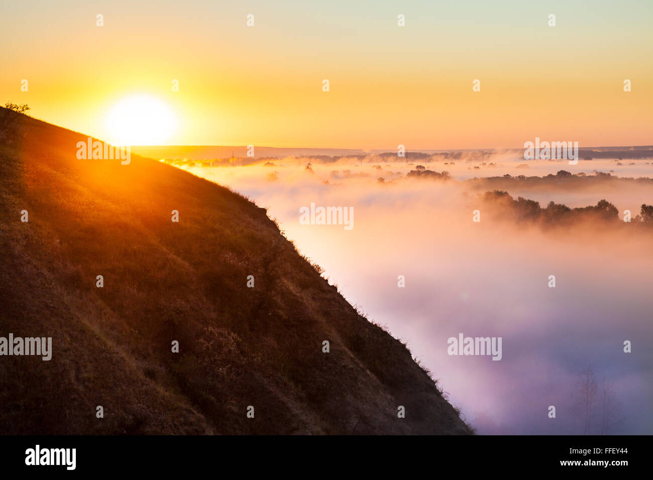 Misty dawn from hill over Valley and the forest Stock Photo - Alamy