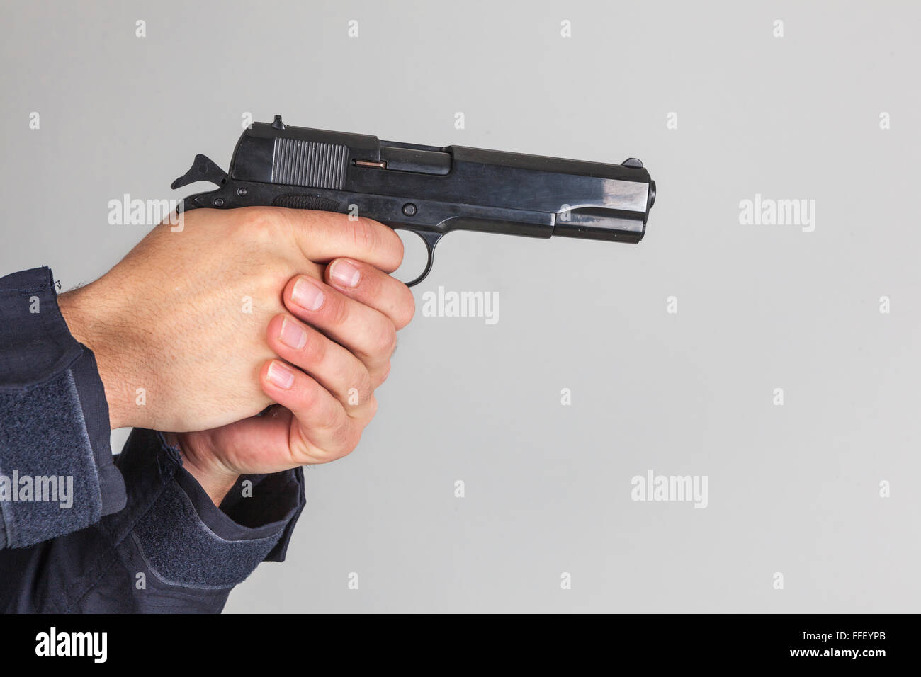 Policeman with gun Stock Photo - Alamy