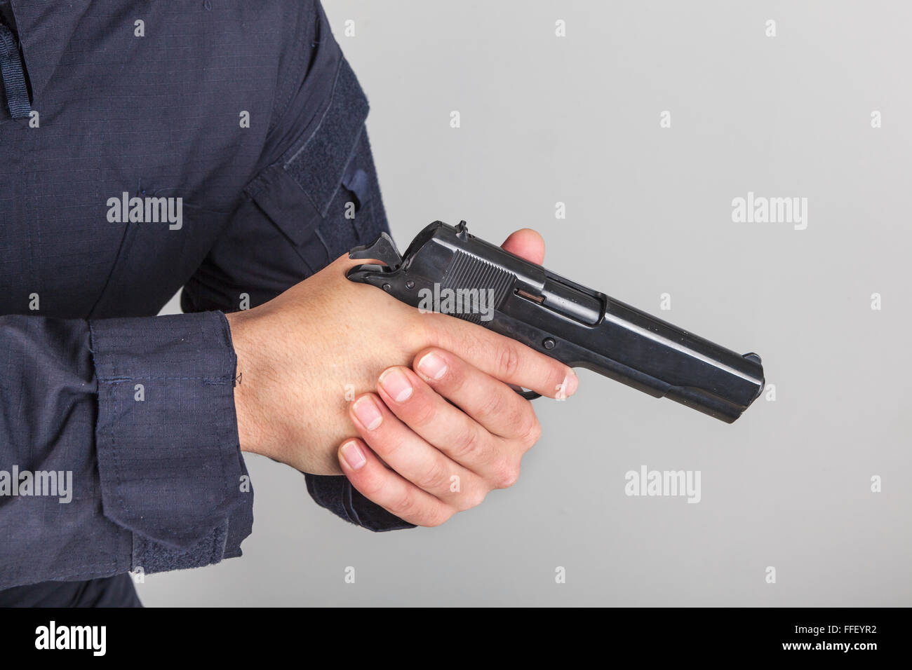 Policeman with gun Stock Photo - Alamy