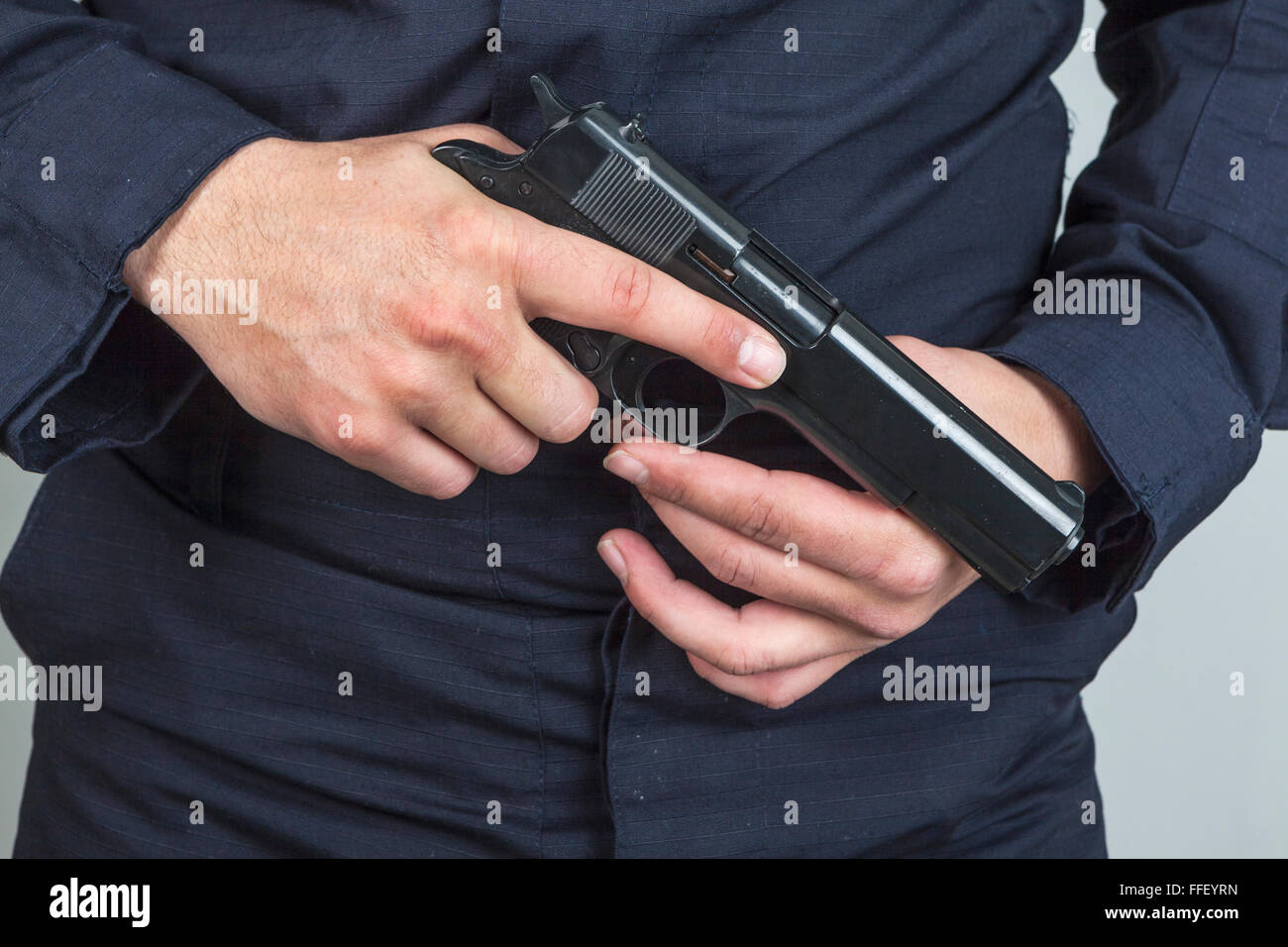 Policeman with gun Stock Photo - Alamy