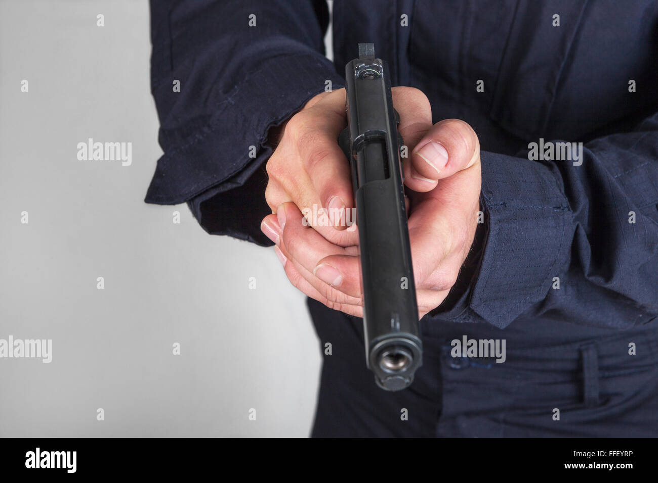 Policeman with gun Stock Photo - Alamy