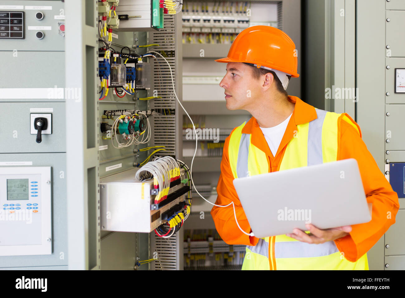 technician checking computerized transformer status with laptop ...