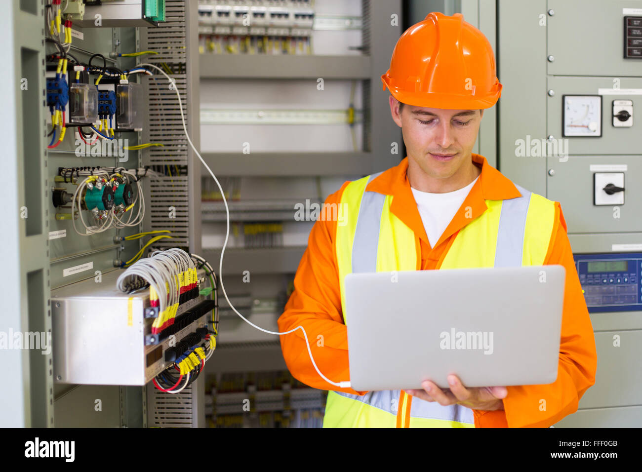 technician checking machine status on laptop computer Stock Photo - Alamy