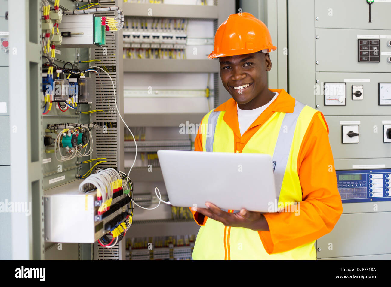 cheerful African American electrical engineer working on laptop Stock ...
