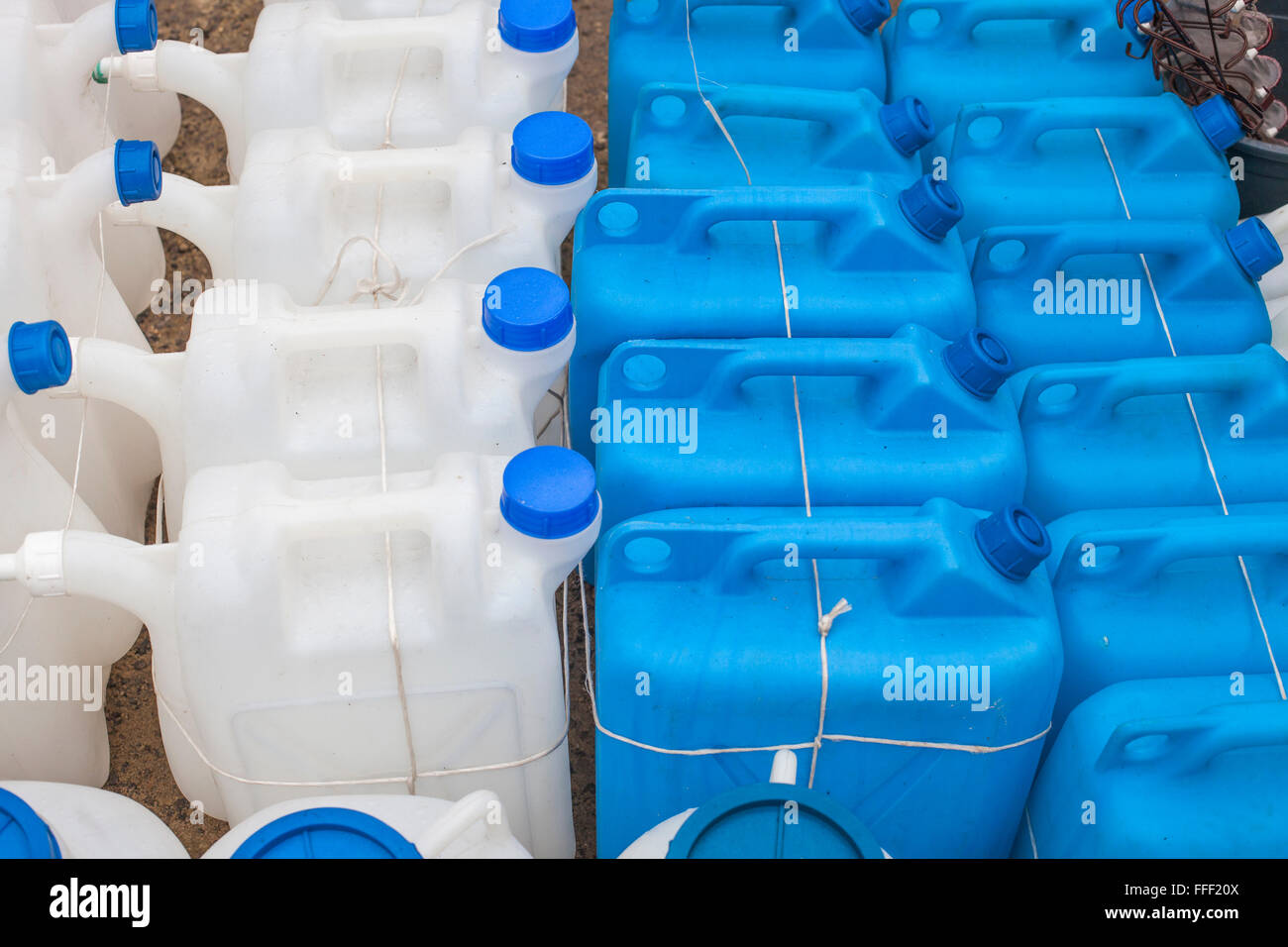 White and blue plastic gas cans (fuel container) in an open market ...