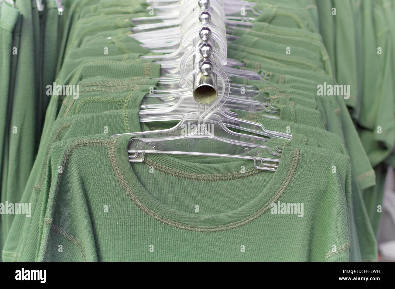green clothes on hangers in daylight Stock Photo - Alamy