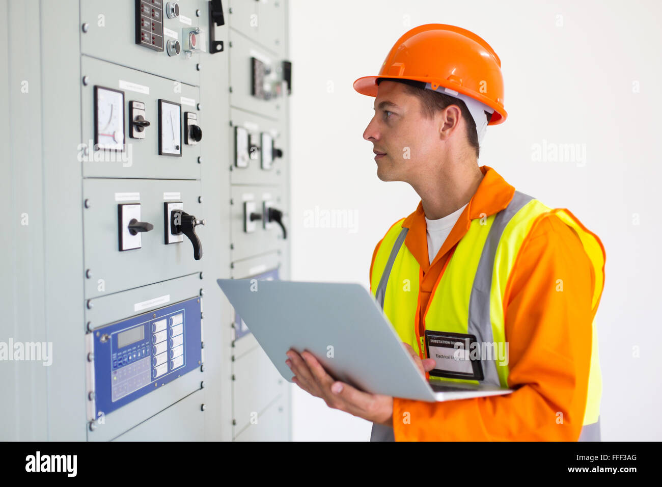 electrical engineer with laptop computer in power plant control room ...