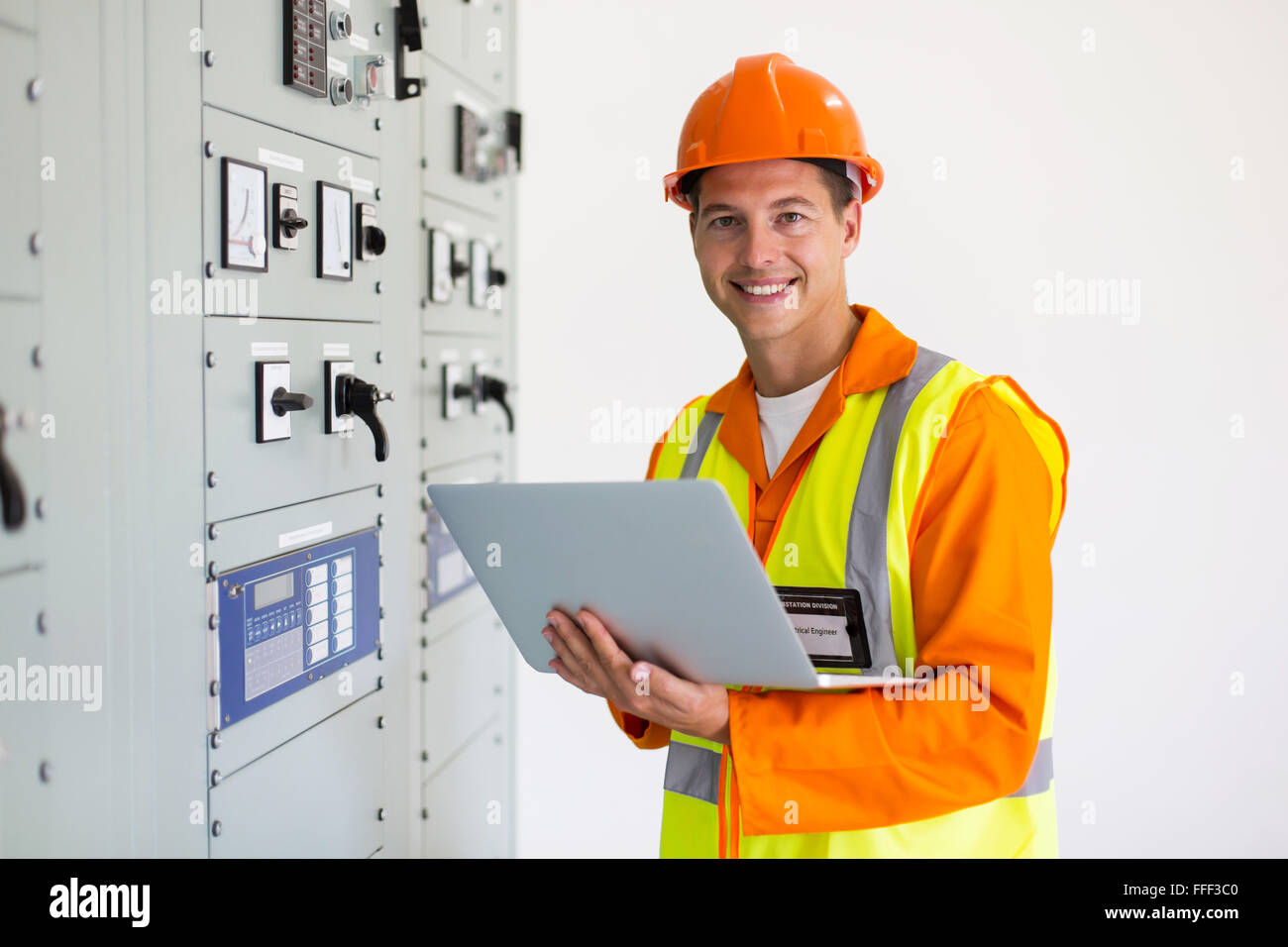 portrait of young engineer with laptop in control room Stock Photo - Alamy