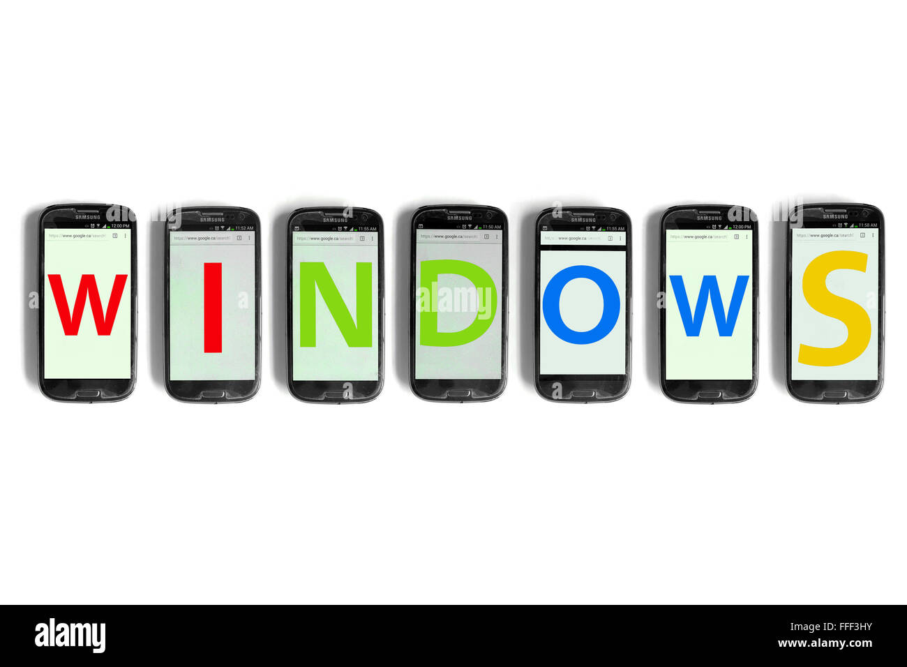 Windows written on the screens of smartphones photographed against a ...
