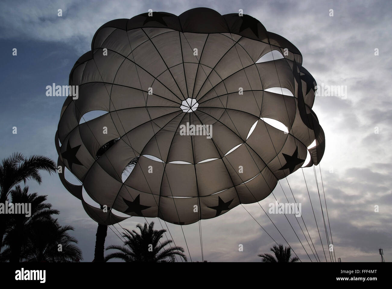 Parachute landing during sunset Stock Photo - Alamy