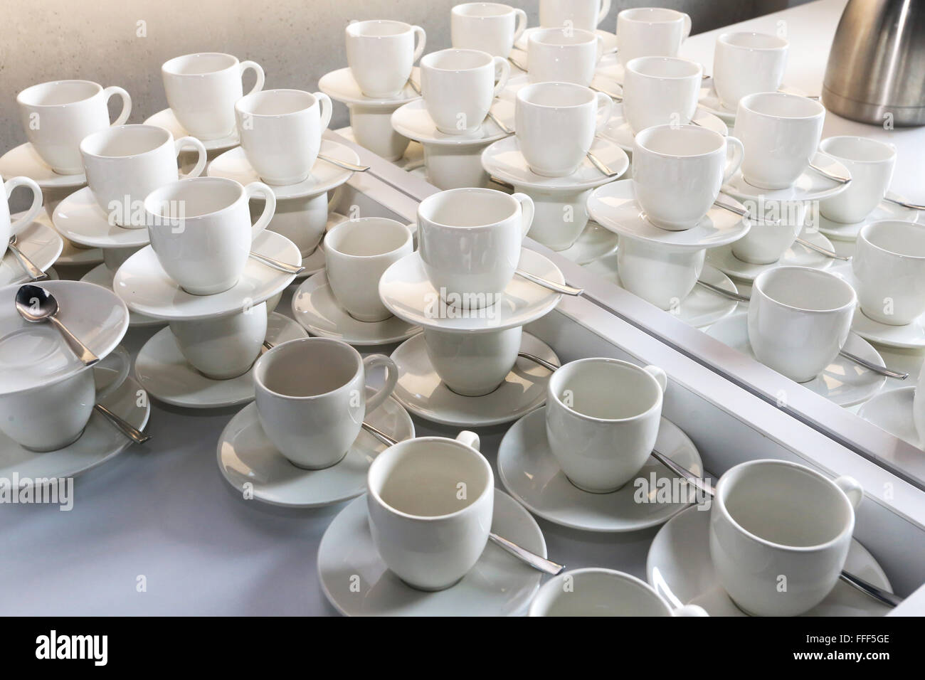 Pure white cups and saucers in rows Stock Photo - Alamy