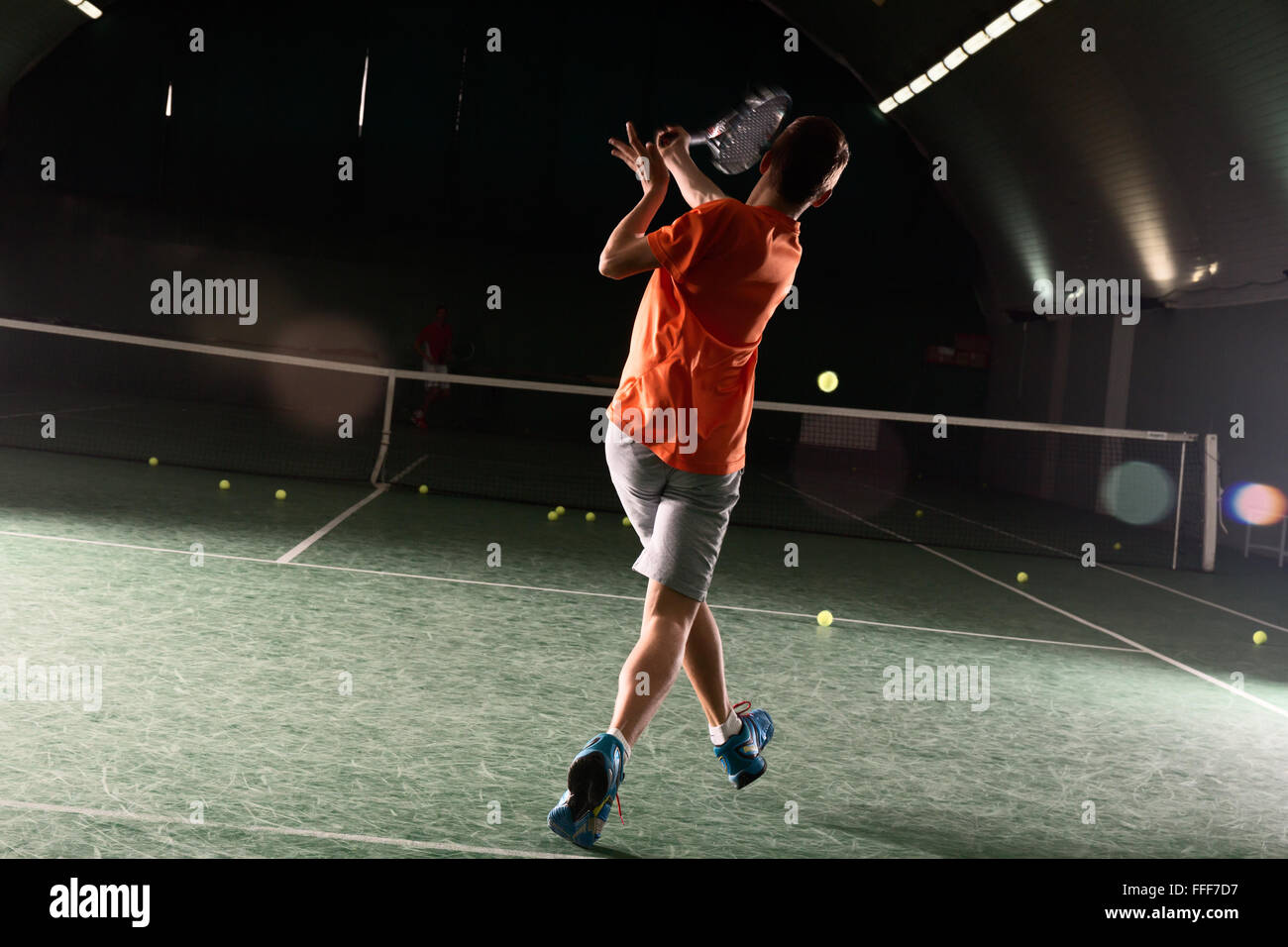 Young tennis player kicking the ball at the training Stock Photo - Alamy