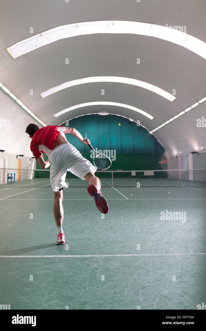 Young tennis player kicking the ball at the training Stock Photo - Alamy