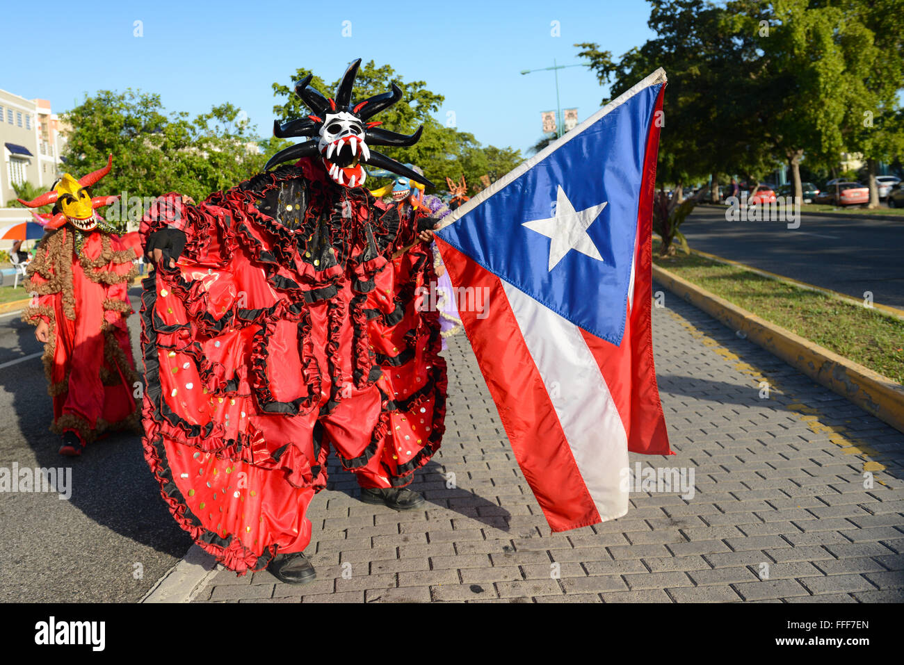 Traditional cultural figure VEJIGANTE posing with flag during the ...