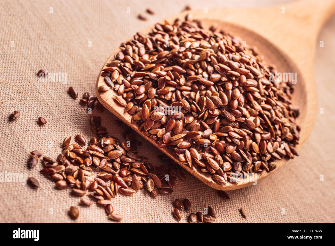 Healthy food for preventing heart diseases and overweight. Flax seeds linseed on wooden spoon ...