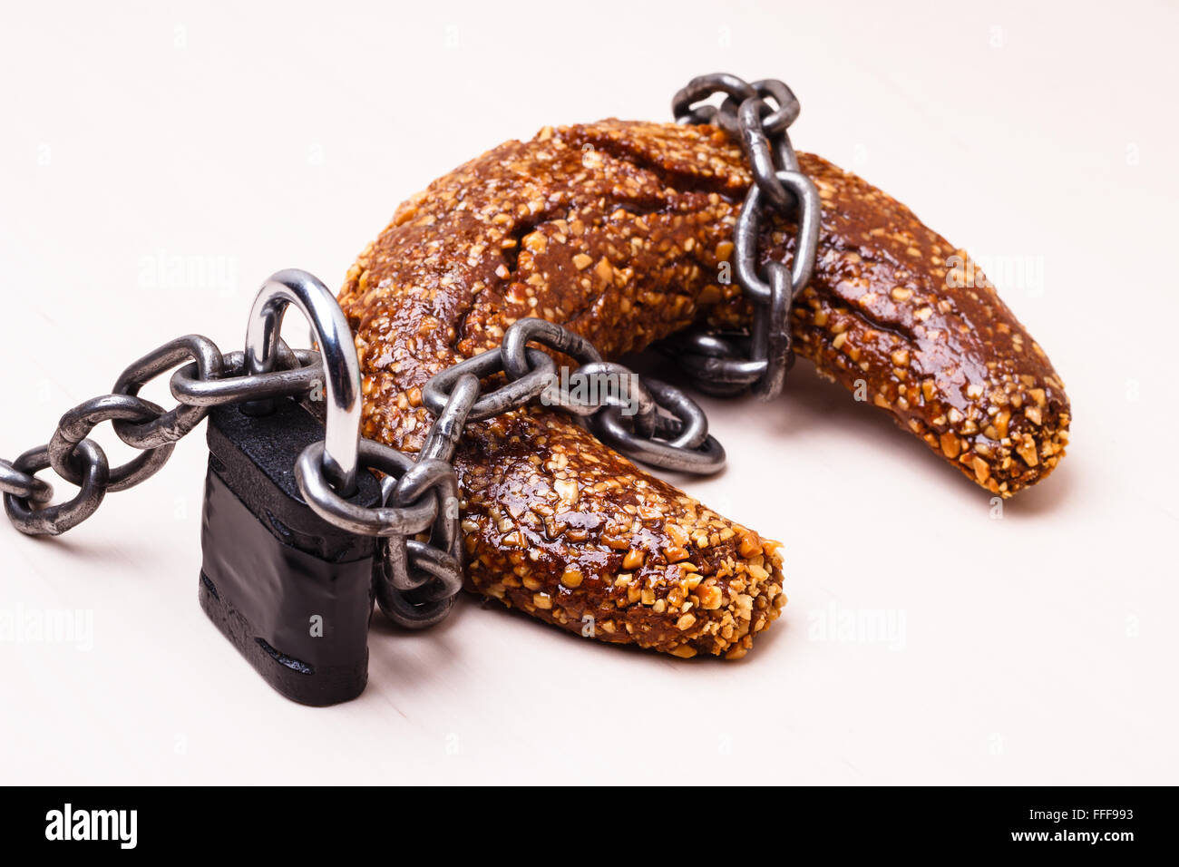 Diet sugar sweet food addiction concept. Cake cupcake wrapped in metal ...