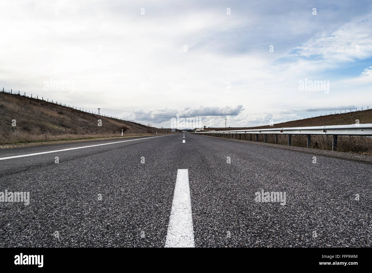 Highway road without traffic in daylight with cloudy sky Stock Photo ...