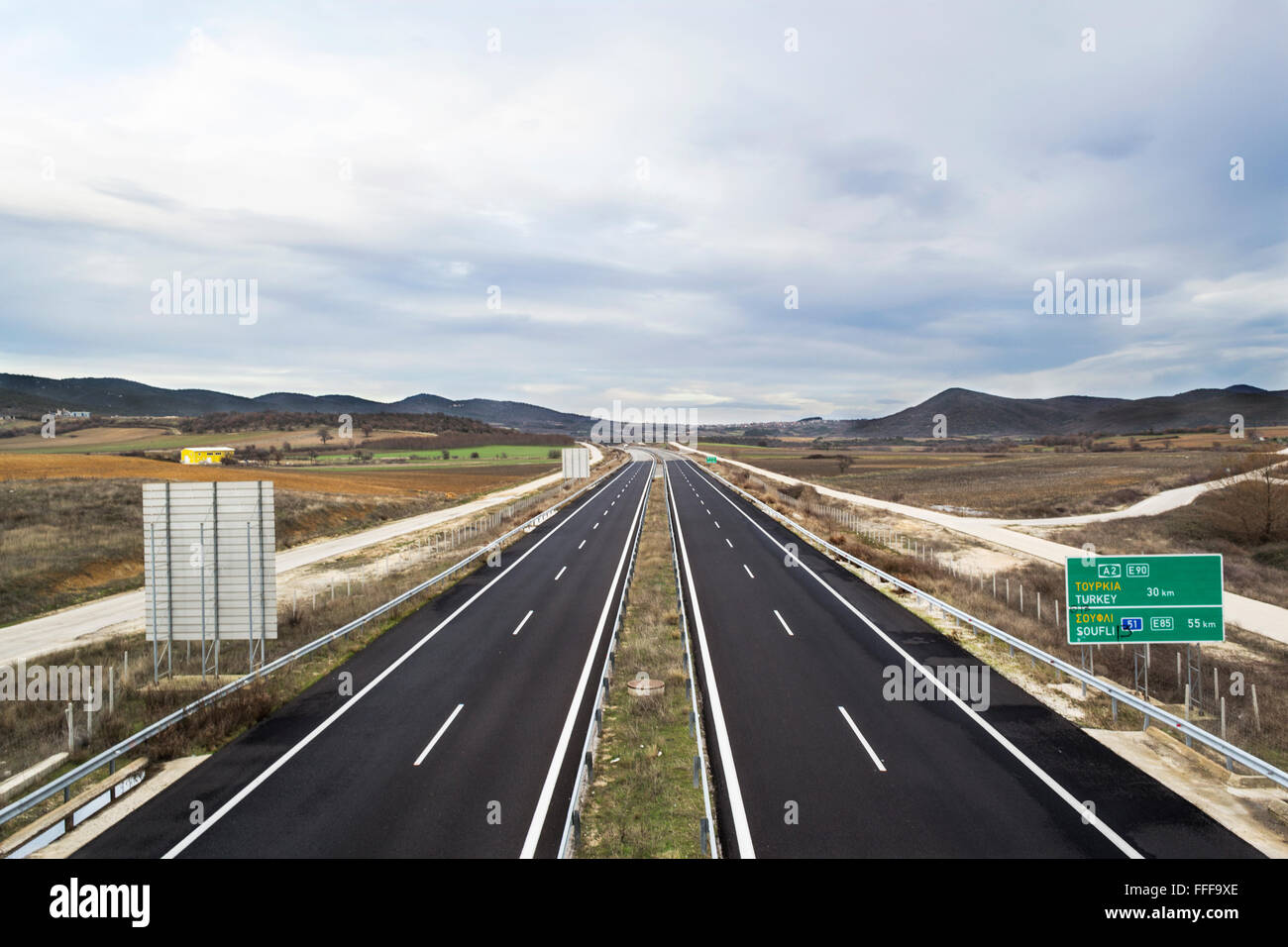 Highway road without traffic in daylight with cloudy sky Stock Photo ...