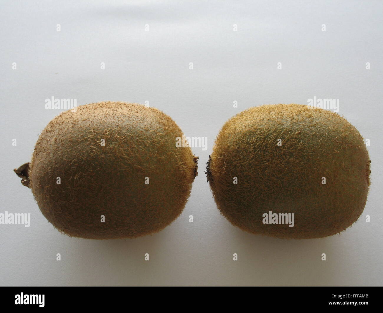 two kiwis on a table Stock Photo - Alamy